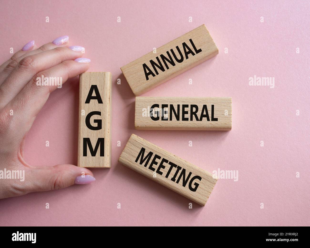 AGM - Annual general meeting symbol. Concept word AGM on wooden blocks ...