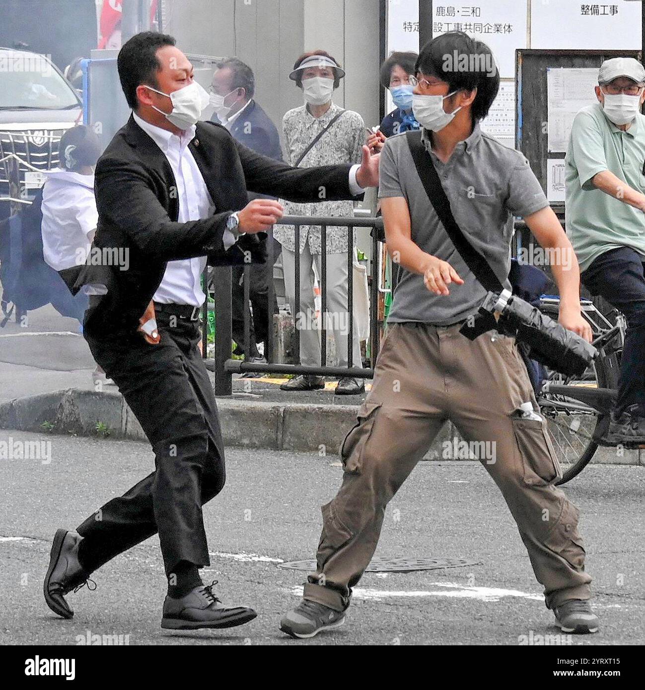 Tetsuya Yamagami is confronted by security guard on 8 July 2022, as ...