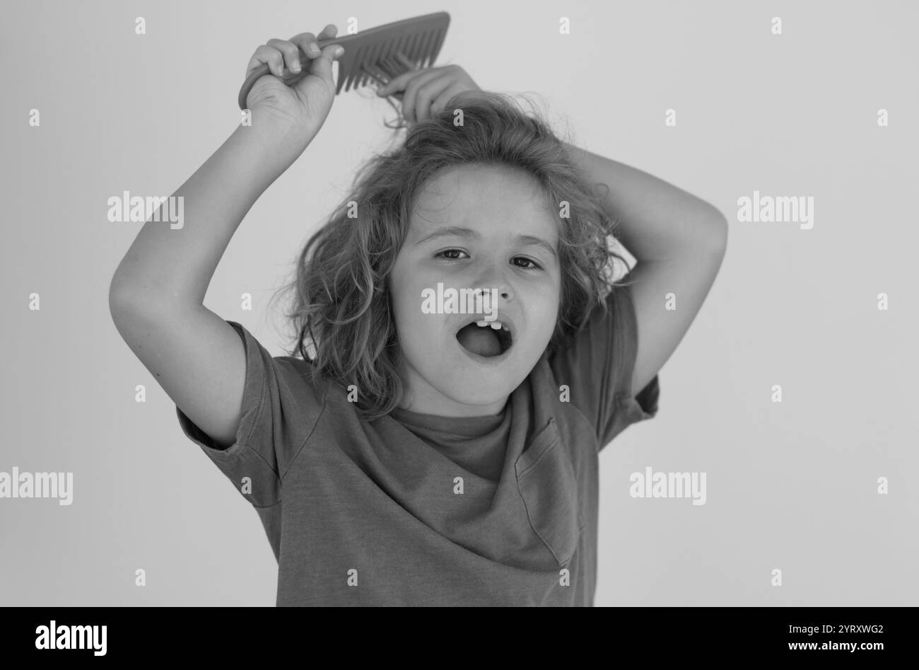 Daily hair care routine. Little child boy combing hair, isolated ...