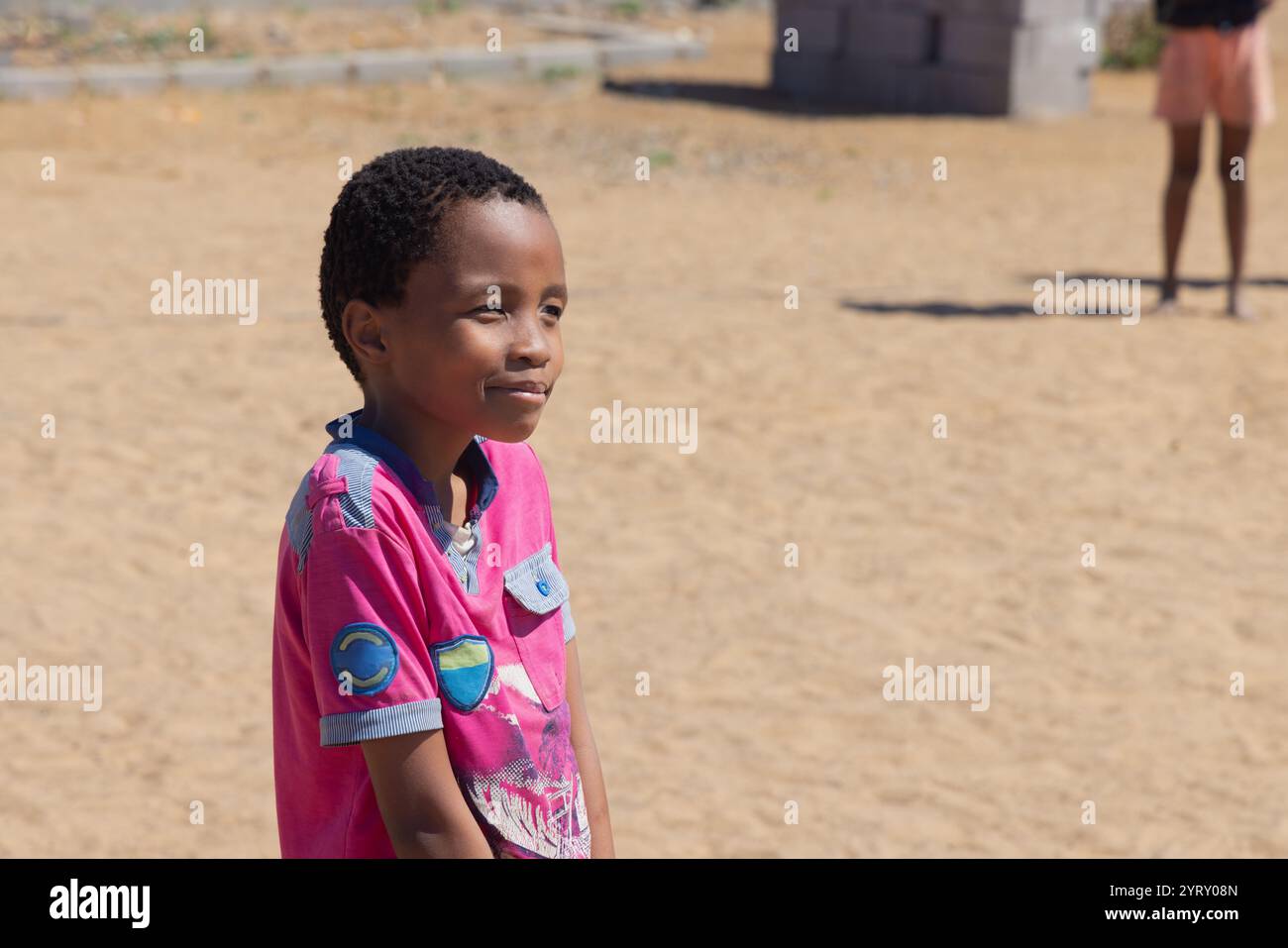 village portrait single african child, standing in the yard ,in the ...