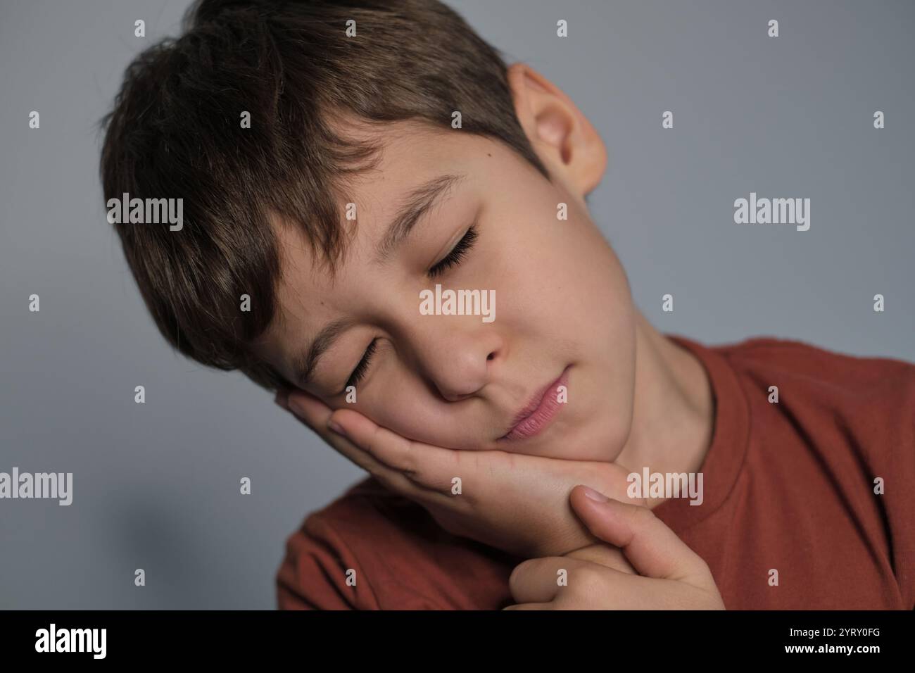 Kid appearing to be in a state of daydream, with a gentle expression ...