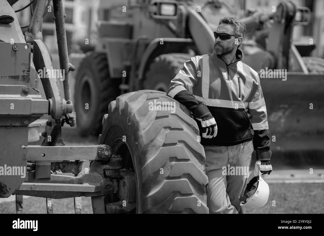 Portrait of builder in a construction site. Builder with excavator ...