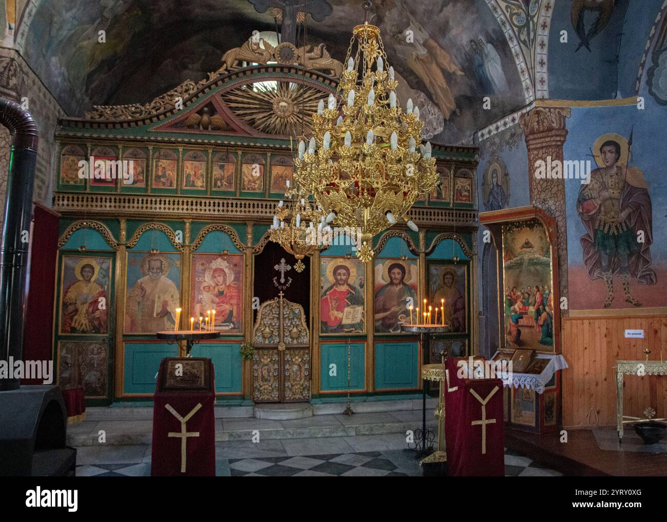 Ornate altar with golden chandelier and vibrant frescoes inside the ...