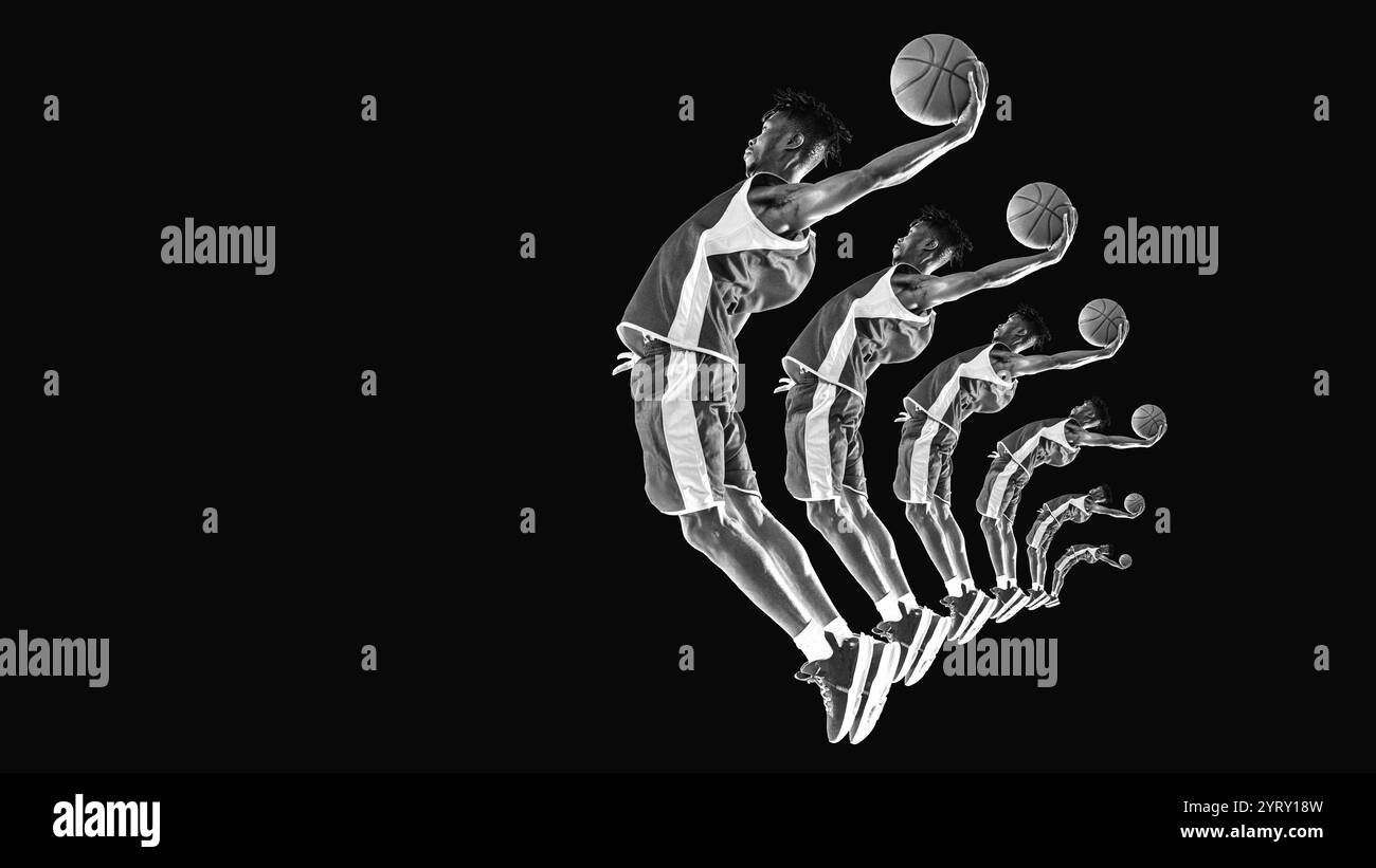 Player captured mid-leap holding basketball, black and white effects ...