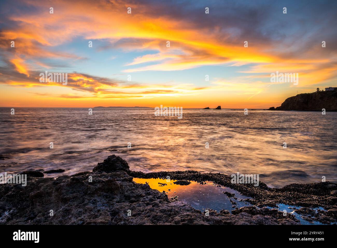 Vibrant sunset colors illuminate Crescent Bay Beach in Laguna Beach ...
