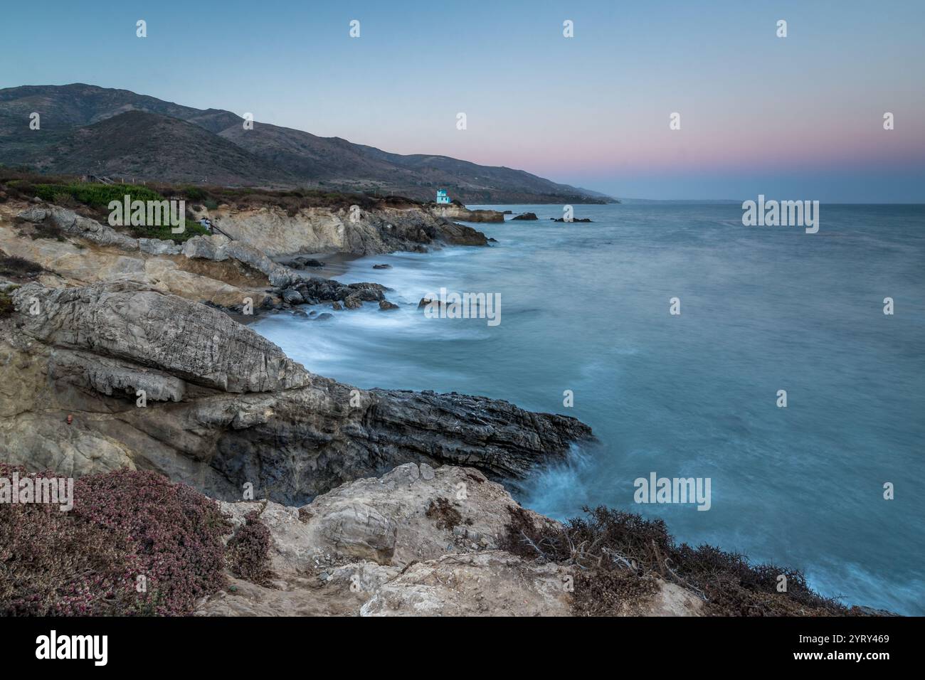 Waves crash against rocky cliffs during twilight at Leo Carrillo State ...