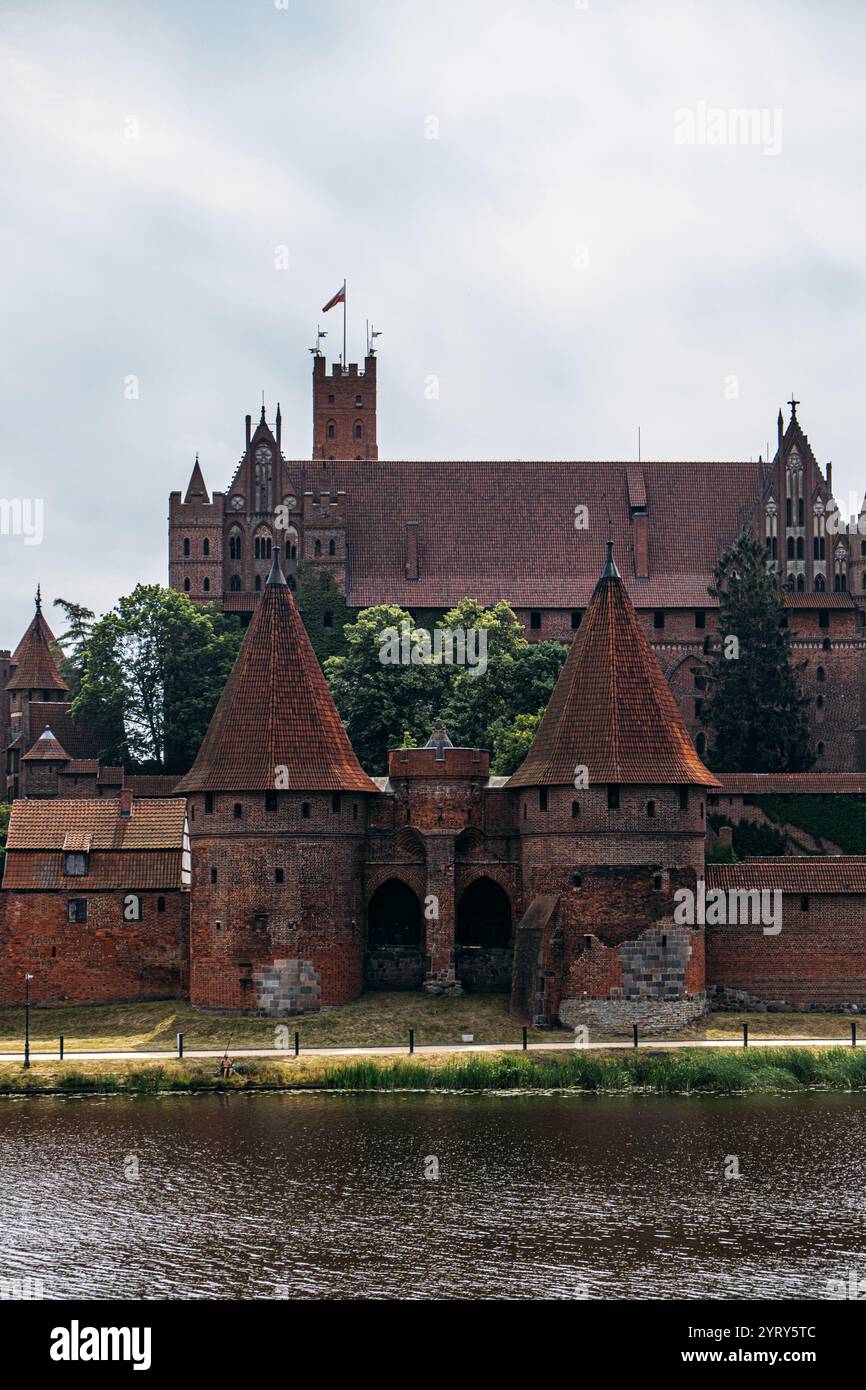 Malbork Castle by the Nogat River with medieval red brick architecture ...