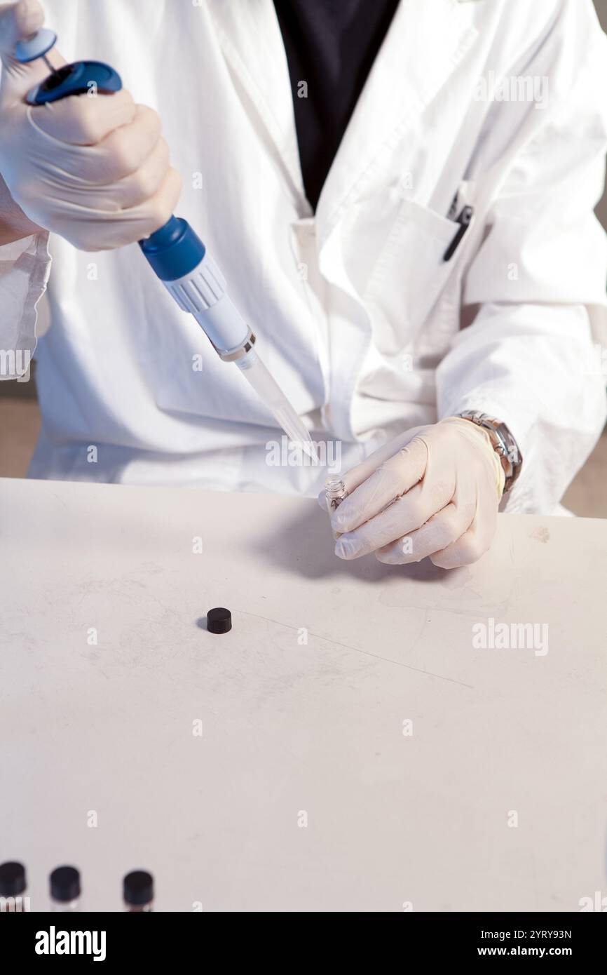 Scientist carefully handling samples in laboratory setting, conducting scientific research using ...