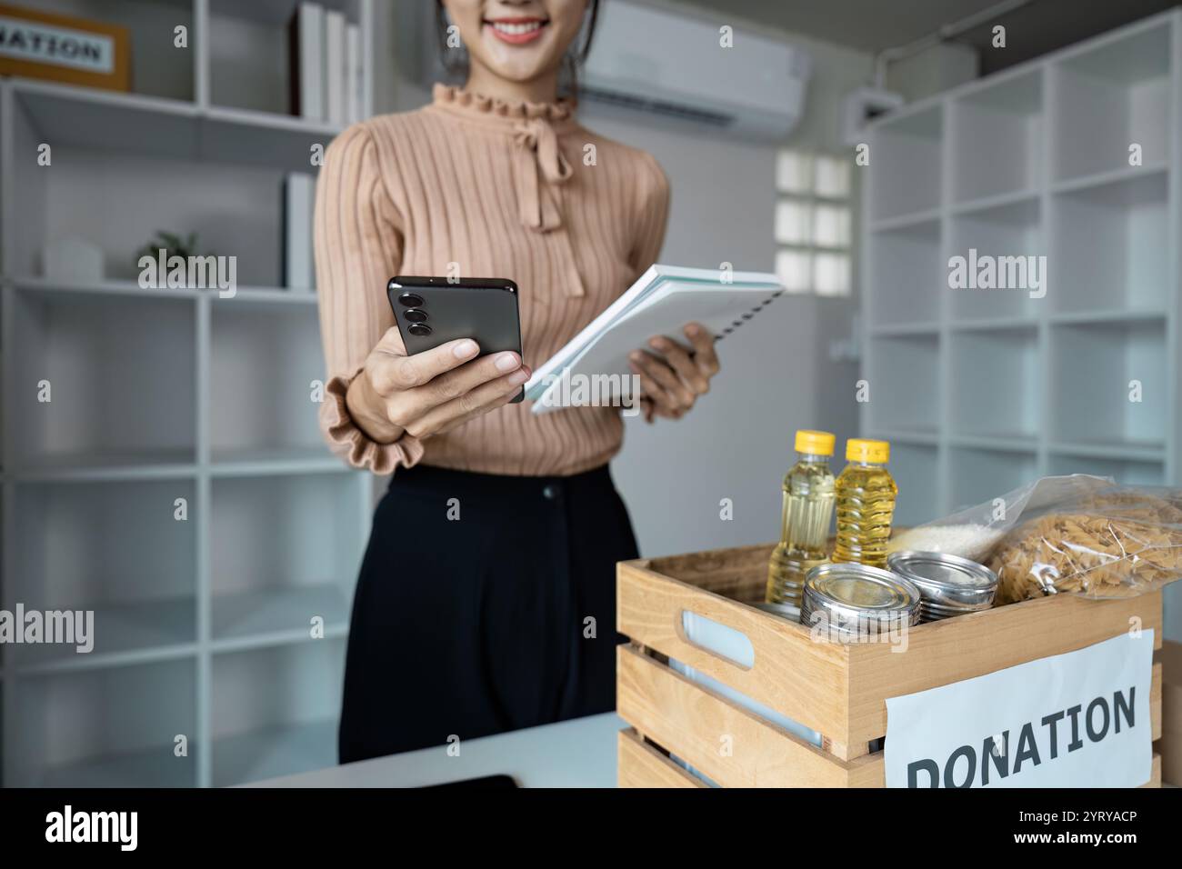 Volunteers Organizing Donations at Food Bank Center for Community Support and Charity Work Stock ...