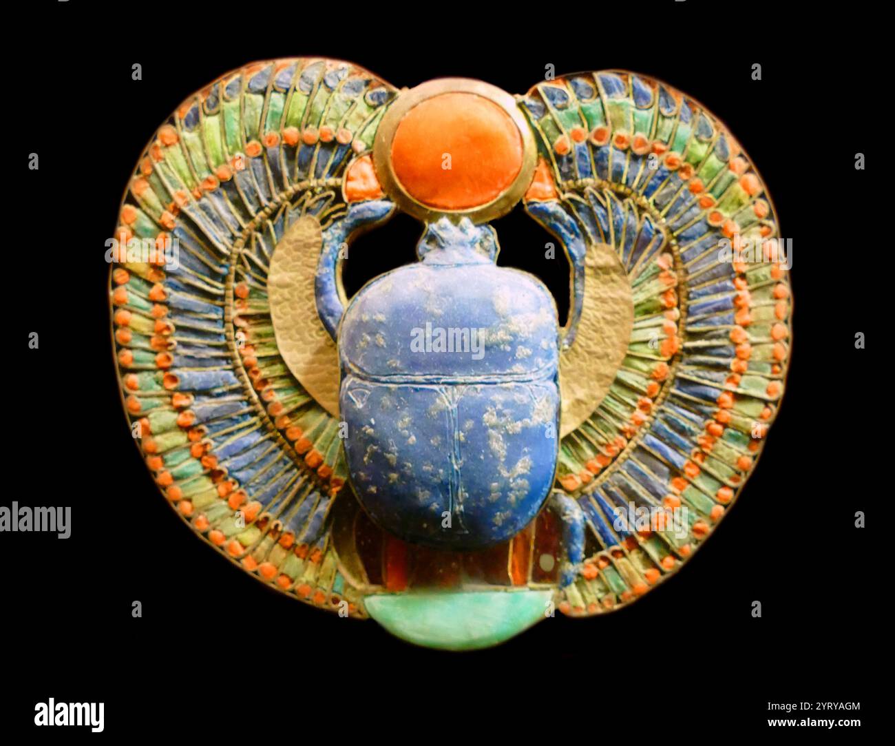 openwork gold Inlaid pectoral depicting a scarab holding a sun dic. The ...