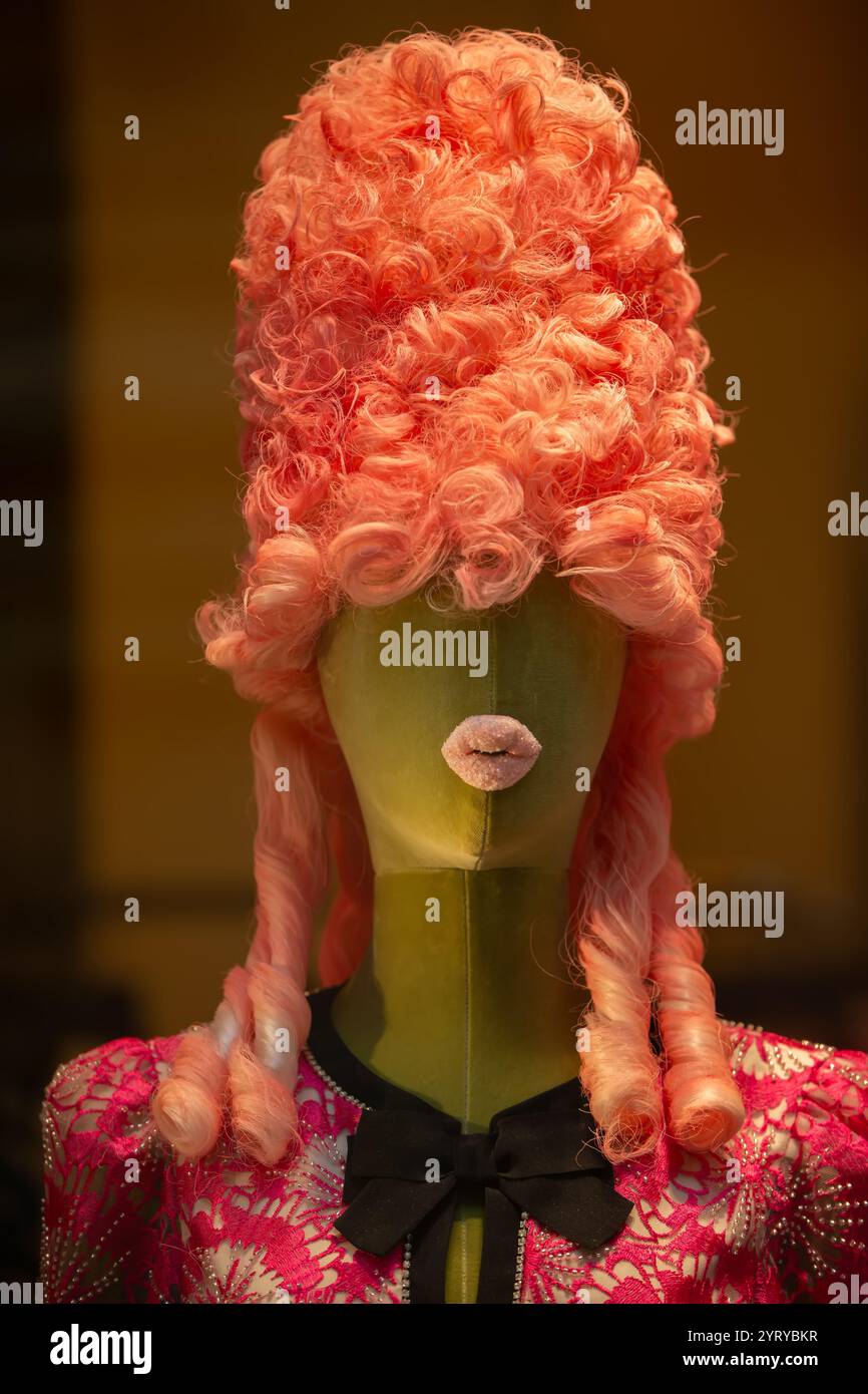 Creative female mannequin in a high retro wig and protruding rag lips ...