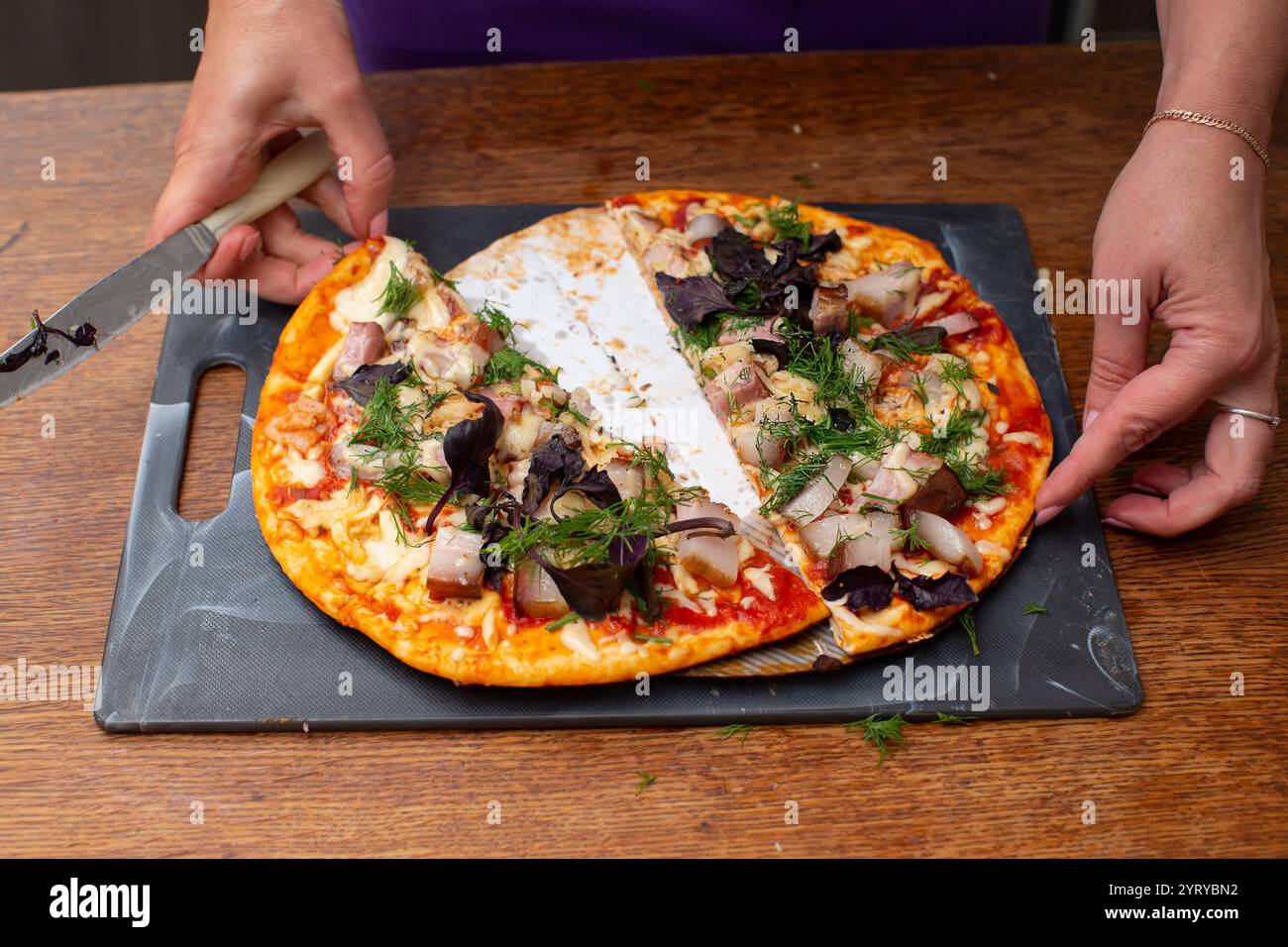 Cut the cheap pizza into pieces Stock Photo - Alamy