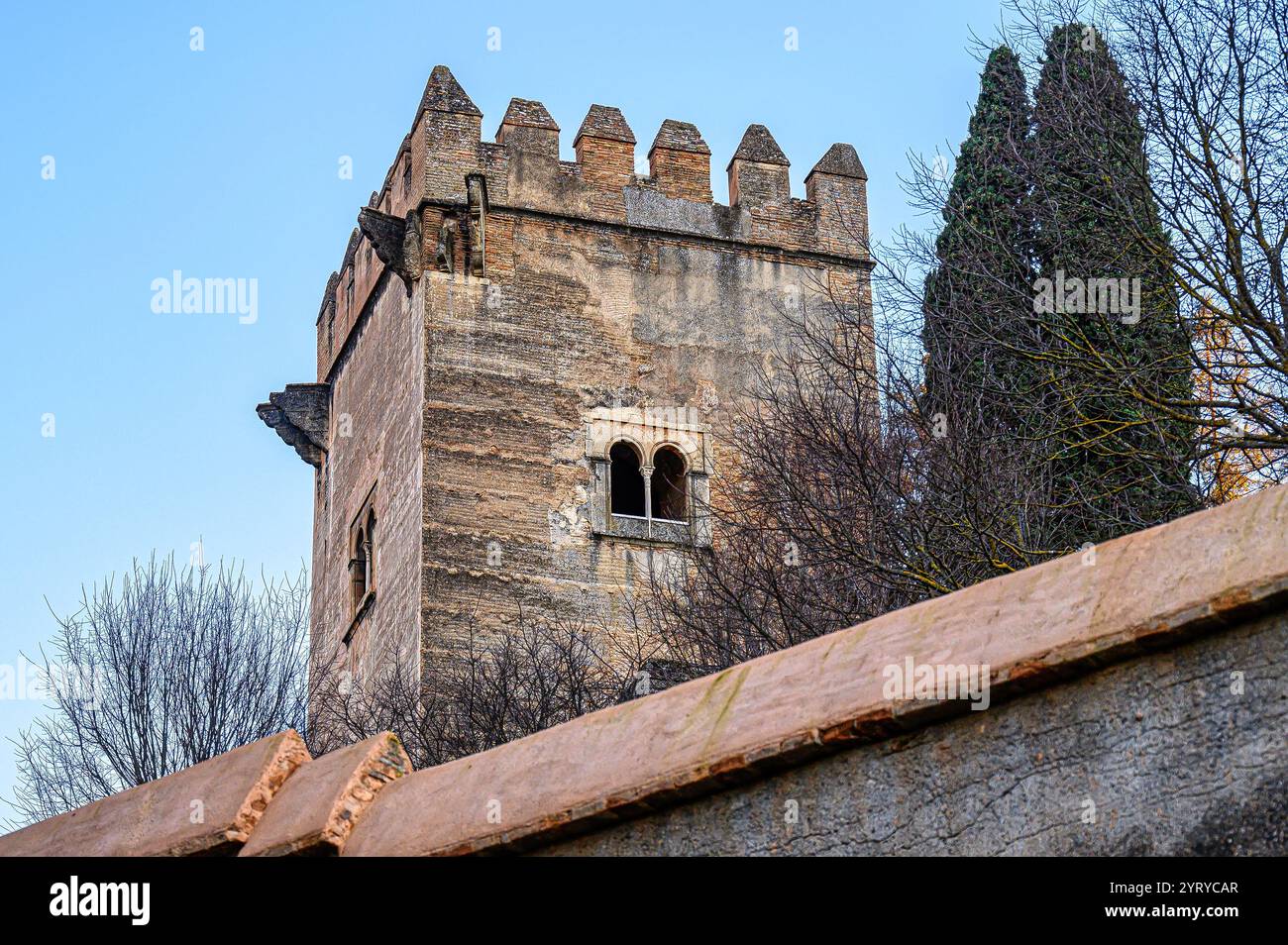 Stone tower with merlons part of the fortifications of the Alhambra ...