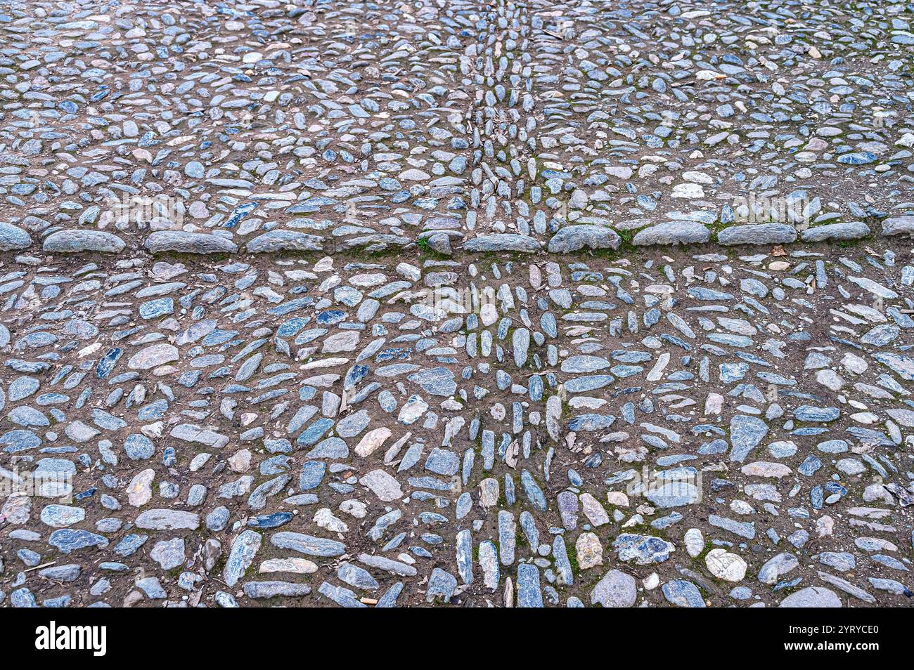 Medieval cobblestone street in the exterior of the the Alhambra palace ...