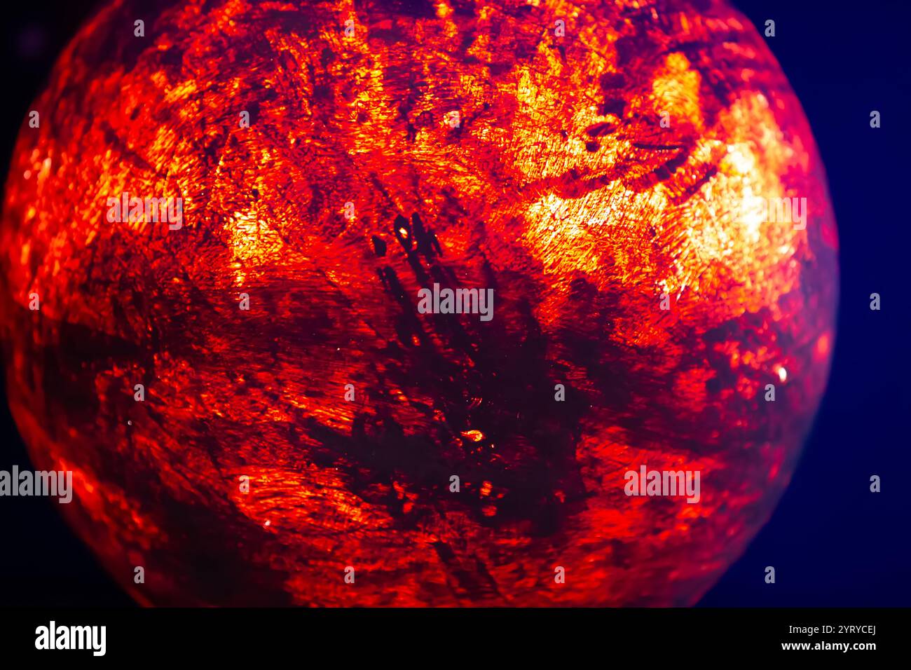 A mock-up of the planet Mars illuminated from the inside on a dark ...