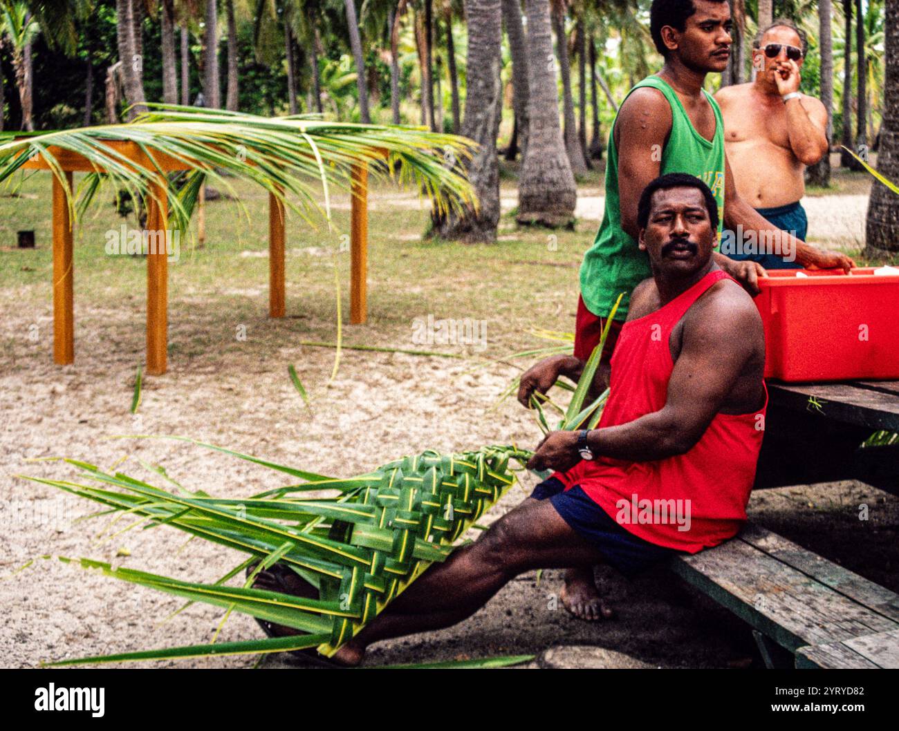 Fijian men preparing a lovo or earth oven, for cooking a traditional ...