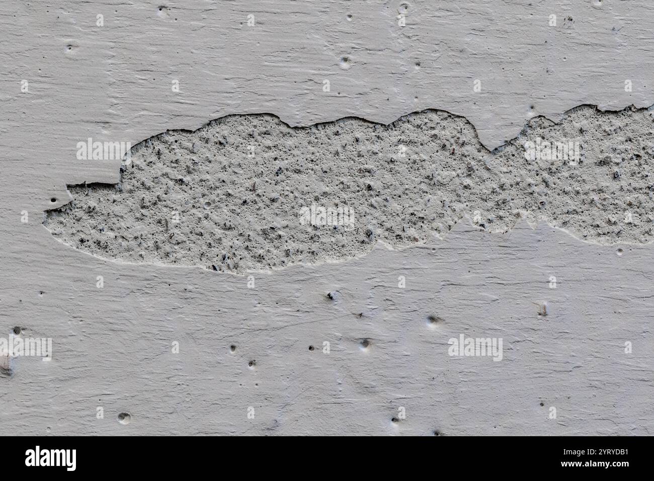 Gray concrete wall surface showing signs of deterioration, cracking ...