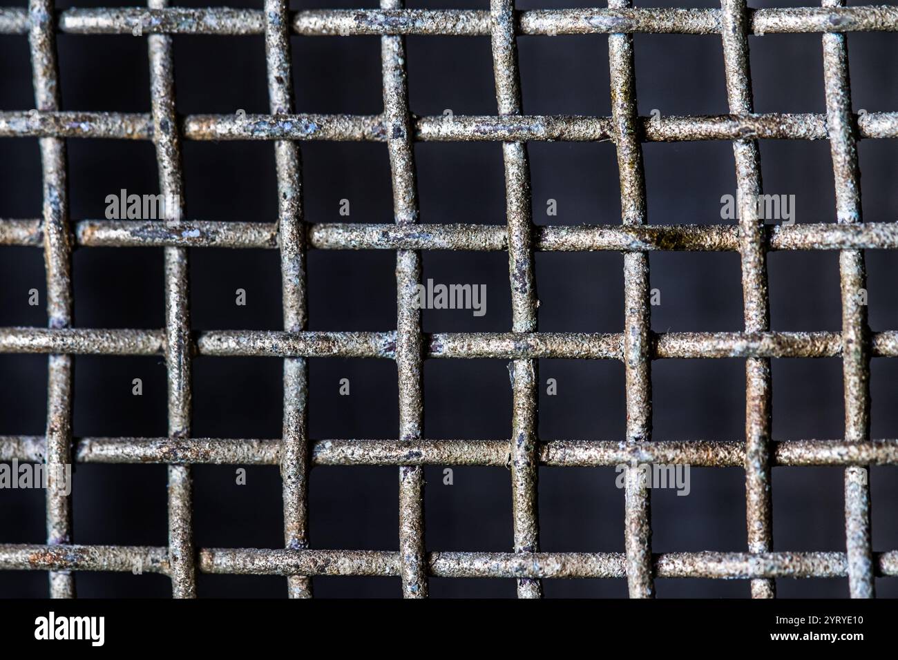 Metal mesh forming regular grid pattern, showcasing texture and ...