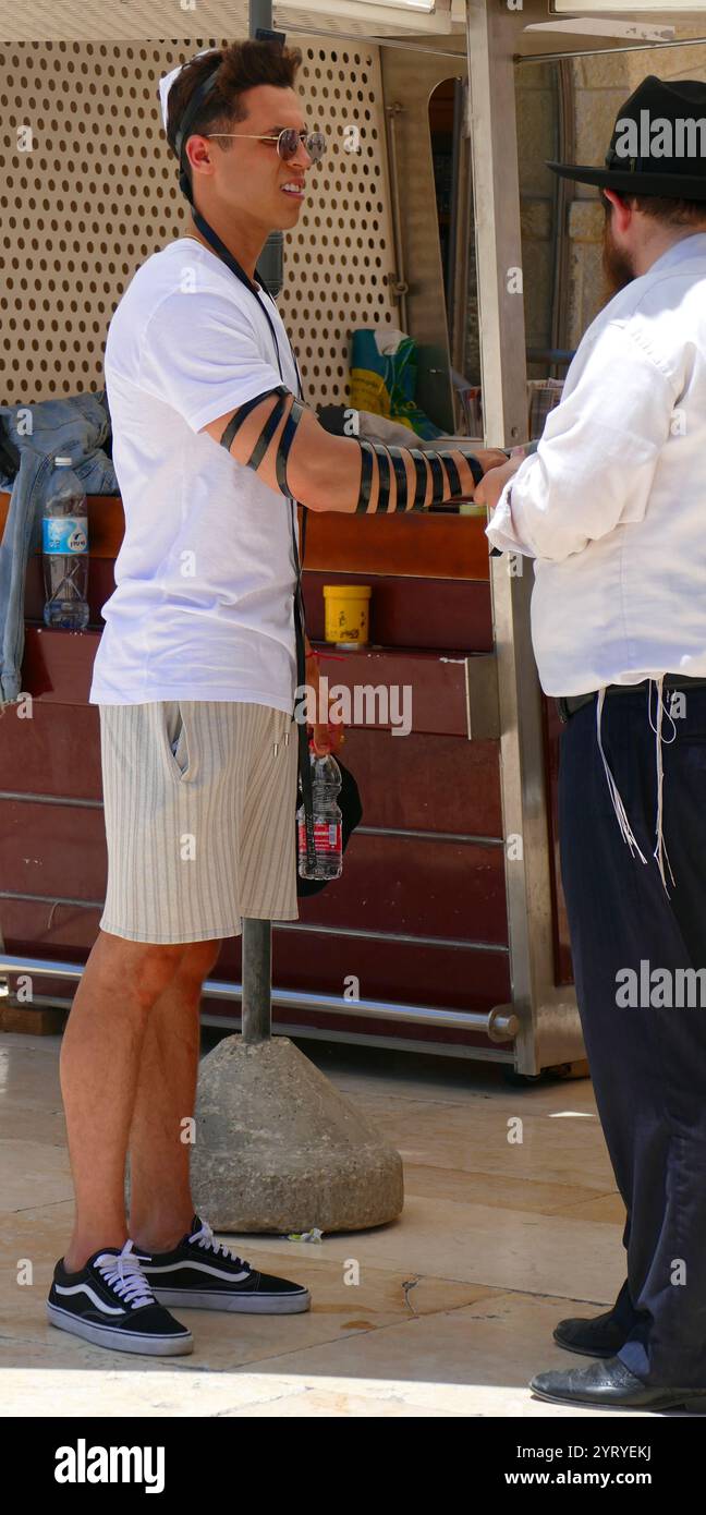 Jew putting on Tefillin during prayers at the Western Wall, (Wailing ...