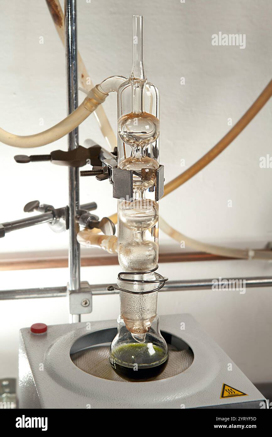 Glassware setup for a chemical reaction experiment, featuring a heating ...