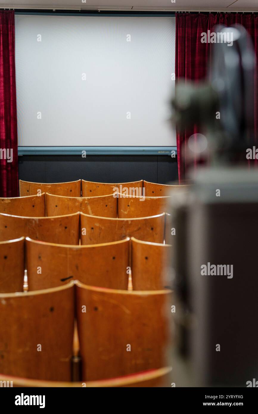 Close-up of a vintage film projector in a cinema hall, highlighting ...