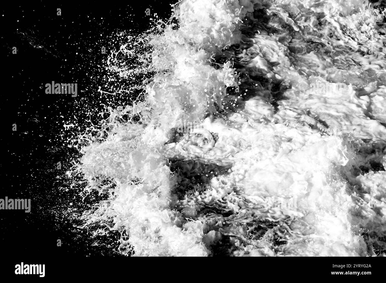 Powerful ocean wave crashing and spraying water drops on dark ...