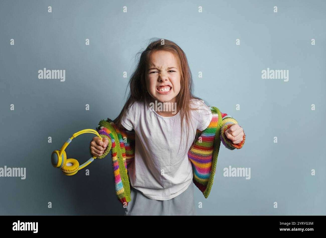 A young girl with long brown hair displays a fierce, angry expression ...