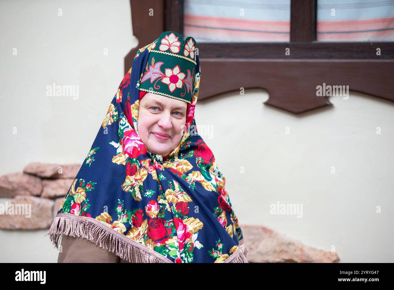 An elderly Russian woman in a traditional headdress, kokoshnik, poses ...