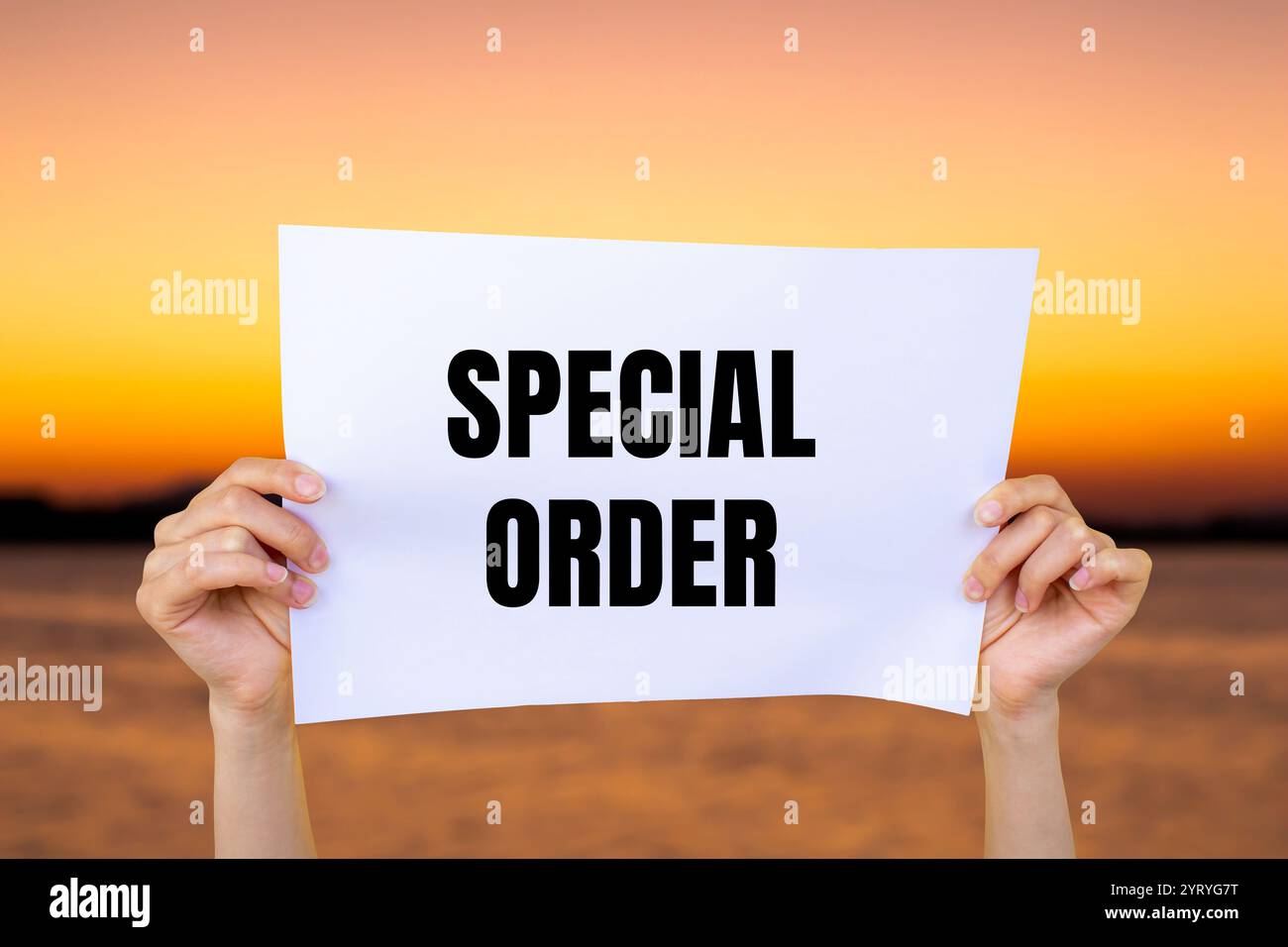 Special order message written on white paper with blurry lake ...