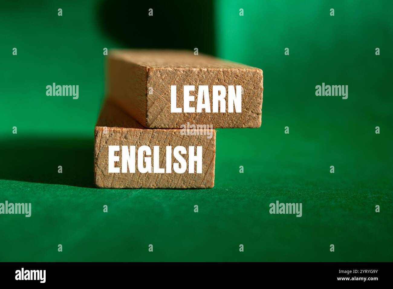 Learn english message written on wooden blocks with green background ...