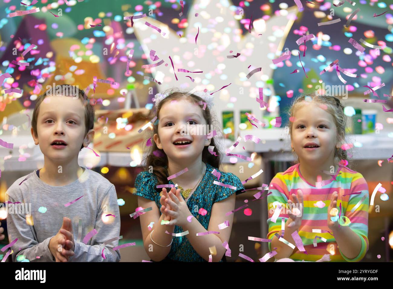 Happy, cheerful children at a children's party clap their hands and ...