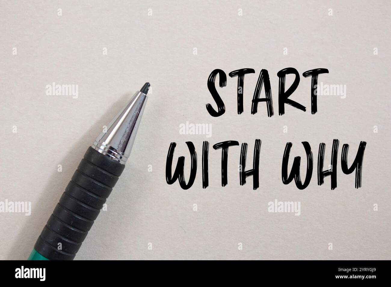 Start with why message written on white paper with a pen. Conceptual ...