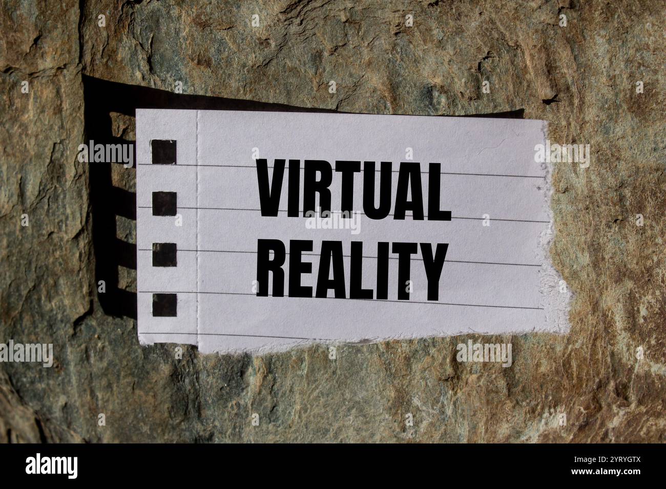 Virtual reality message written on ripped torn paper piece with stone ...