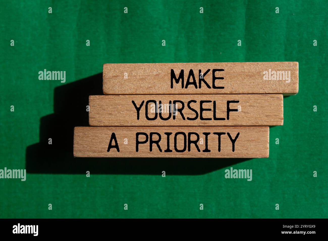 Make yourself a priority message written on wooden blocks with green ...