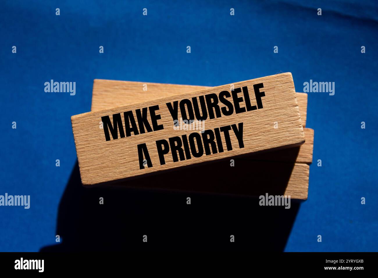 Make yourself a priority message written on wooden blocks with blue ...
