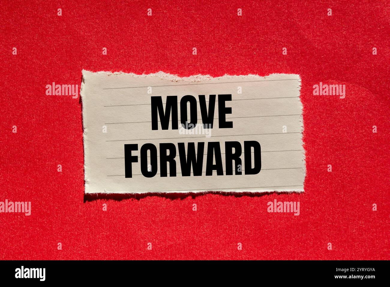 Move forward message written on ripped torn paper piece with red background. Conceptual move ...