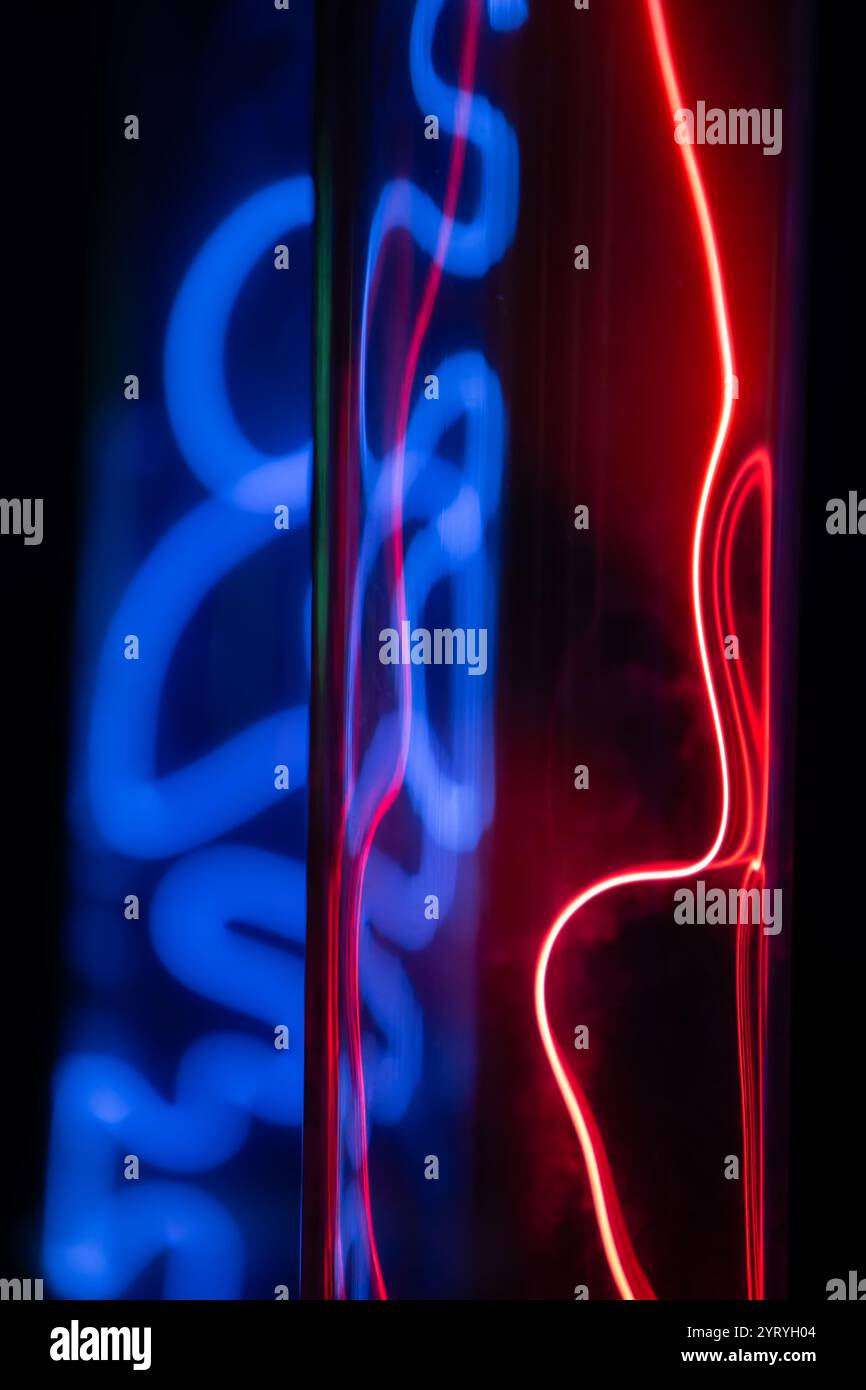 A purple and blue glowing tube with a red line running through it. The ...