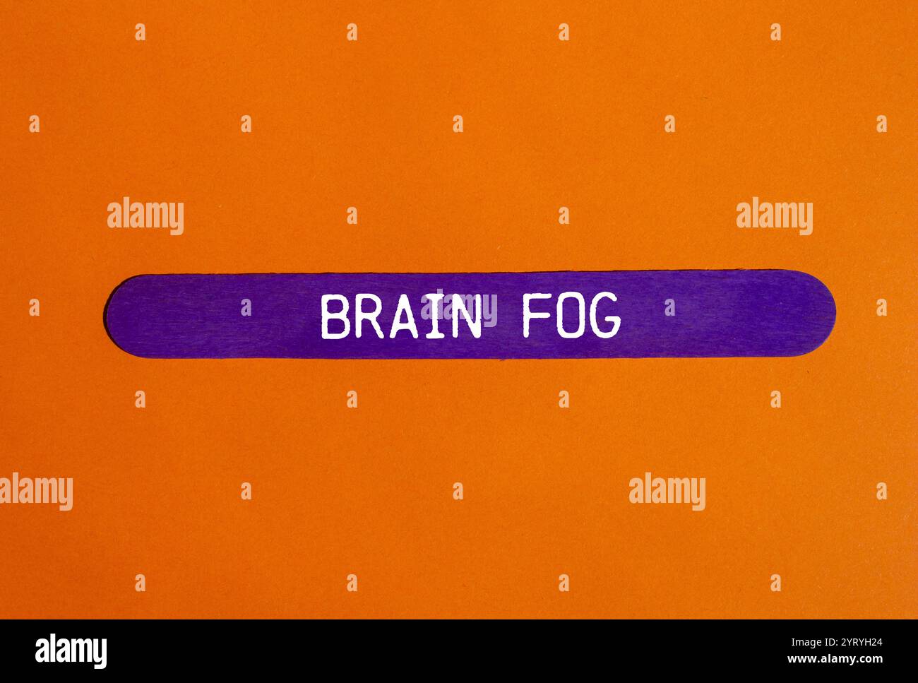 Brain fog message written on purple wooden stick with orange background ...