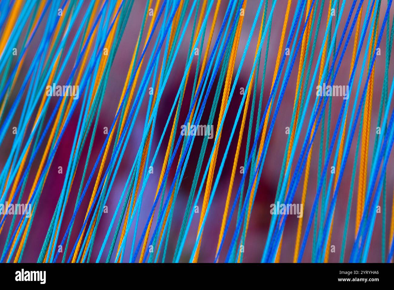 Colorful threads hanging vertically, creating a vibrant and textured ...