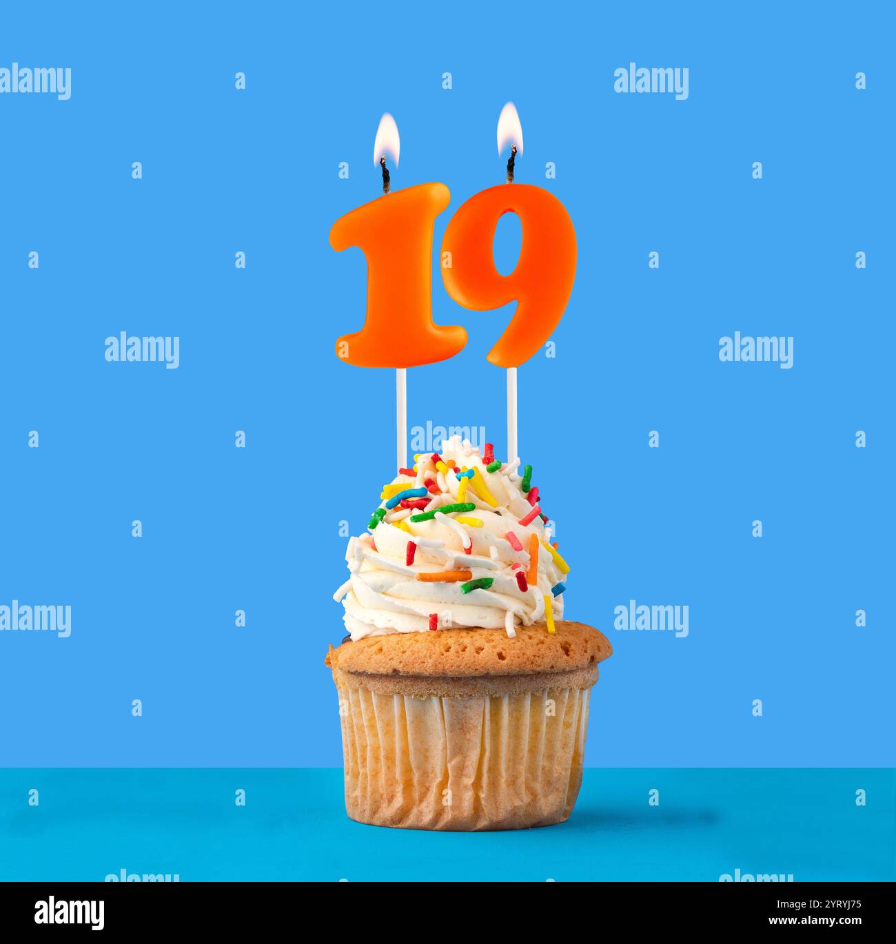 Orange birthday candle and cupcake - Number 19 Stock Photo - Alamy