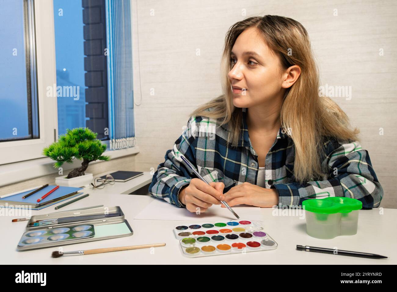Calm female painter drawing with watercolor. Girl artist freely uses ...