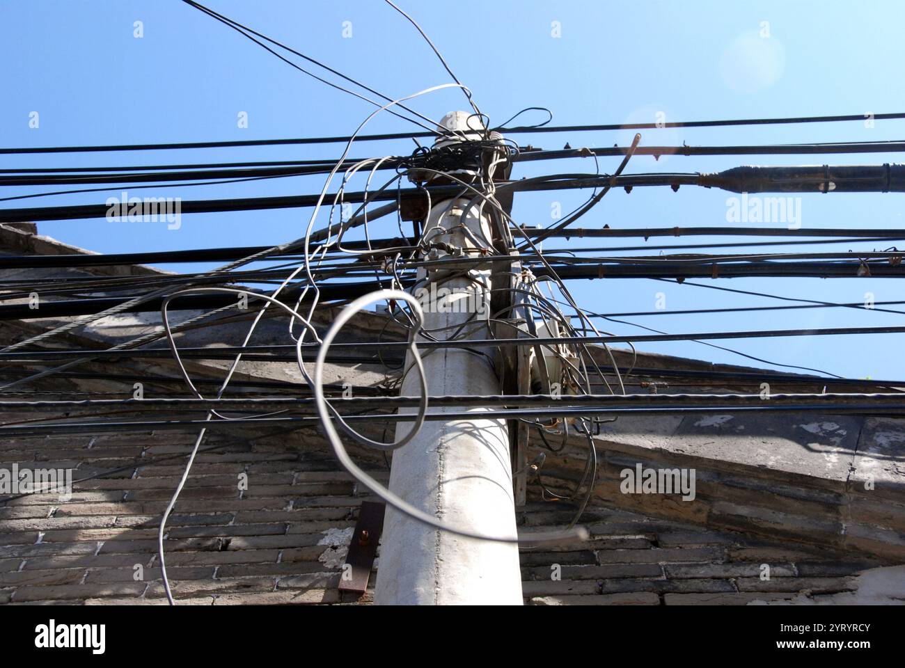 Electricity power cables hanging precariously in the side streets of ...