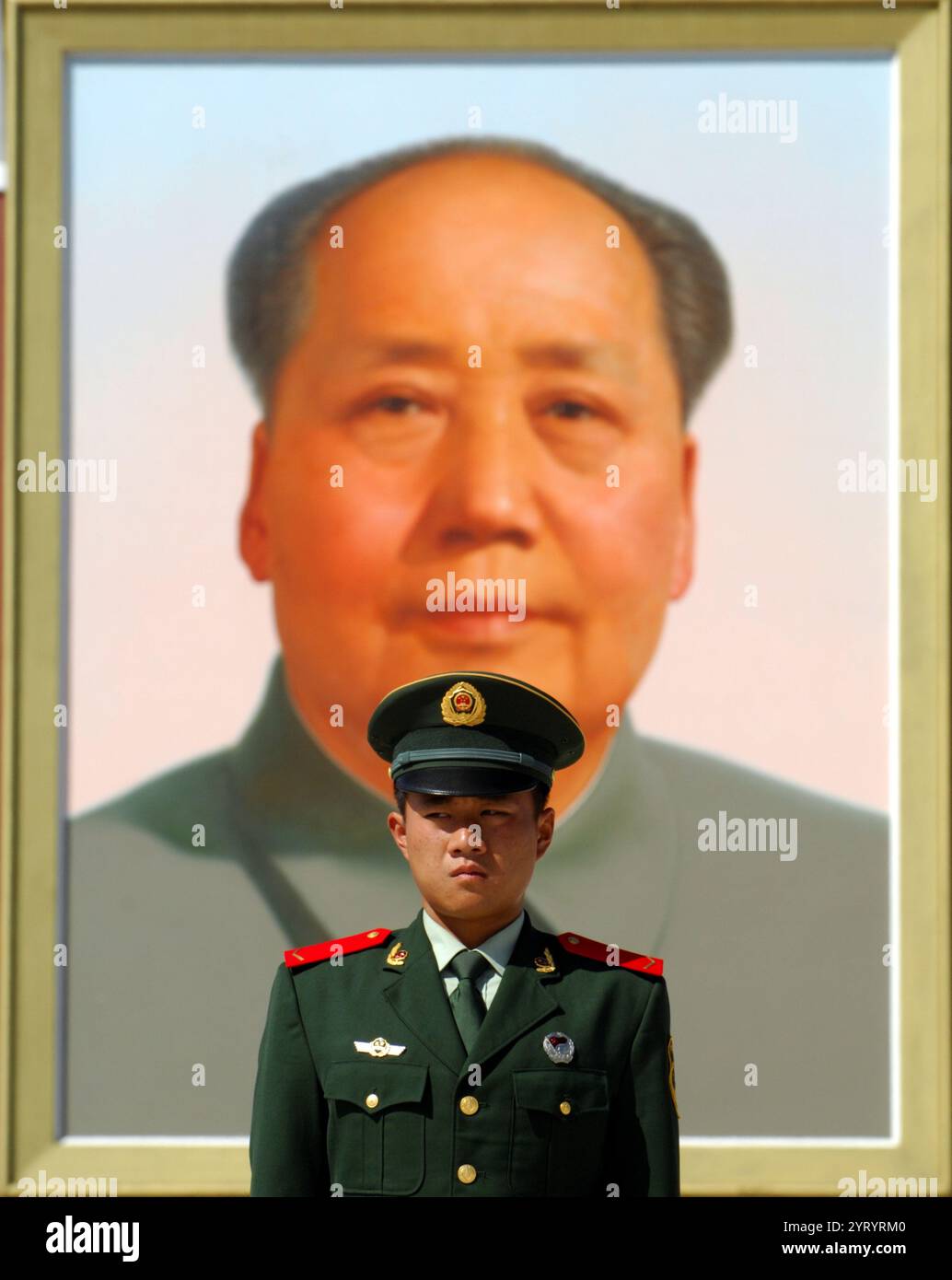 PLA soldier stands guard before a portrait of Chairman, Mao Zedong ...