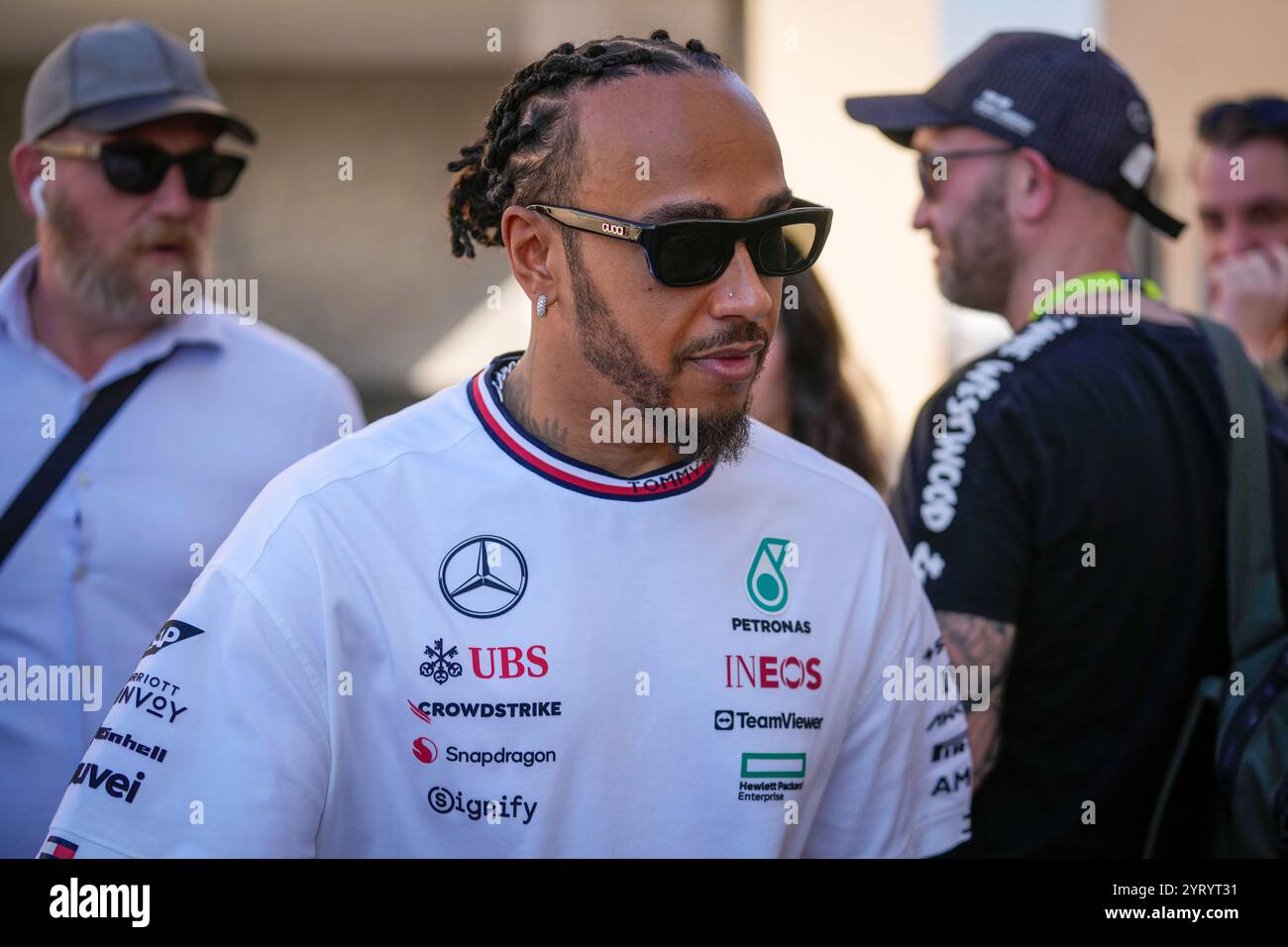Mercedes driver Lewis Hamilton of Britain walks through paddock ahead ...
