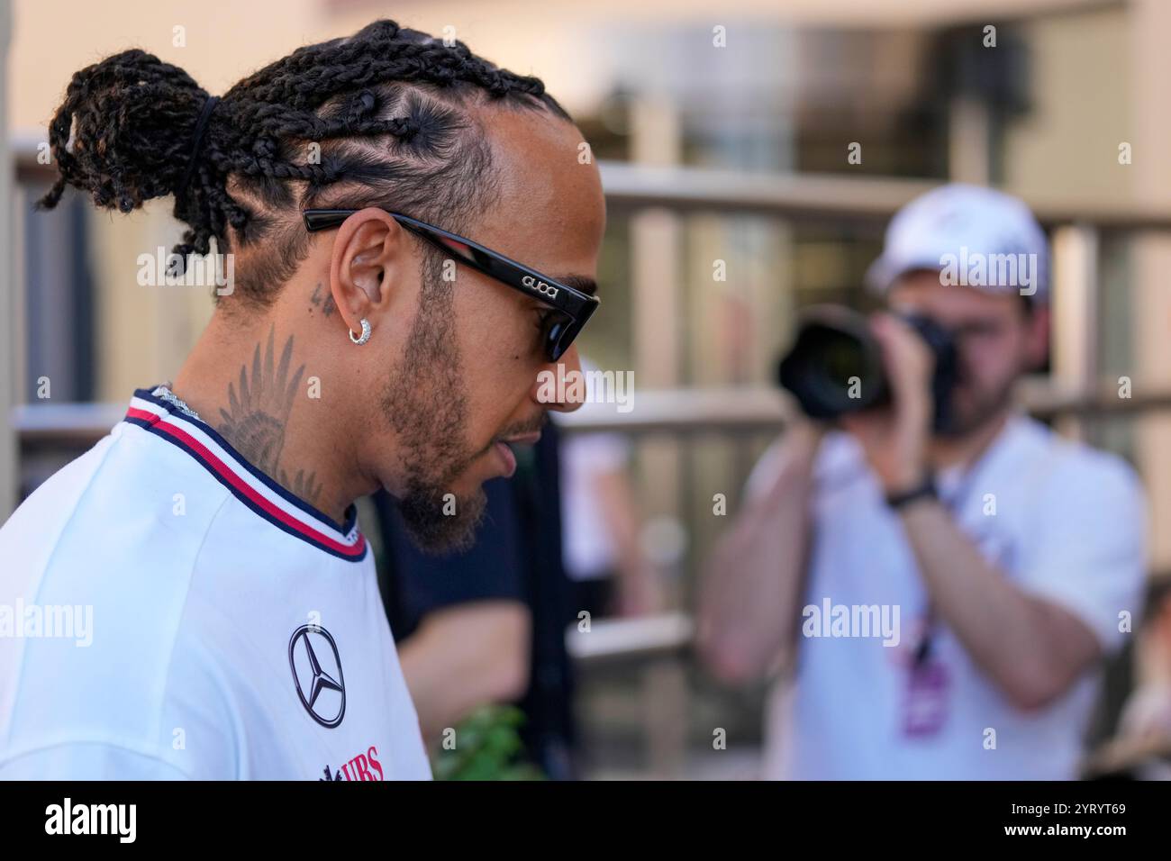 Mercedes driver Lewis Hamilton of Britain walks through paddock ahead ...