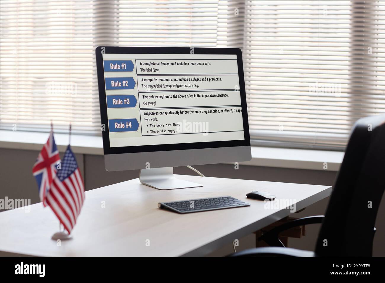 Still life shot of teachers computer on desk displaying English grammar ...