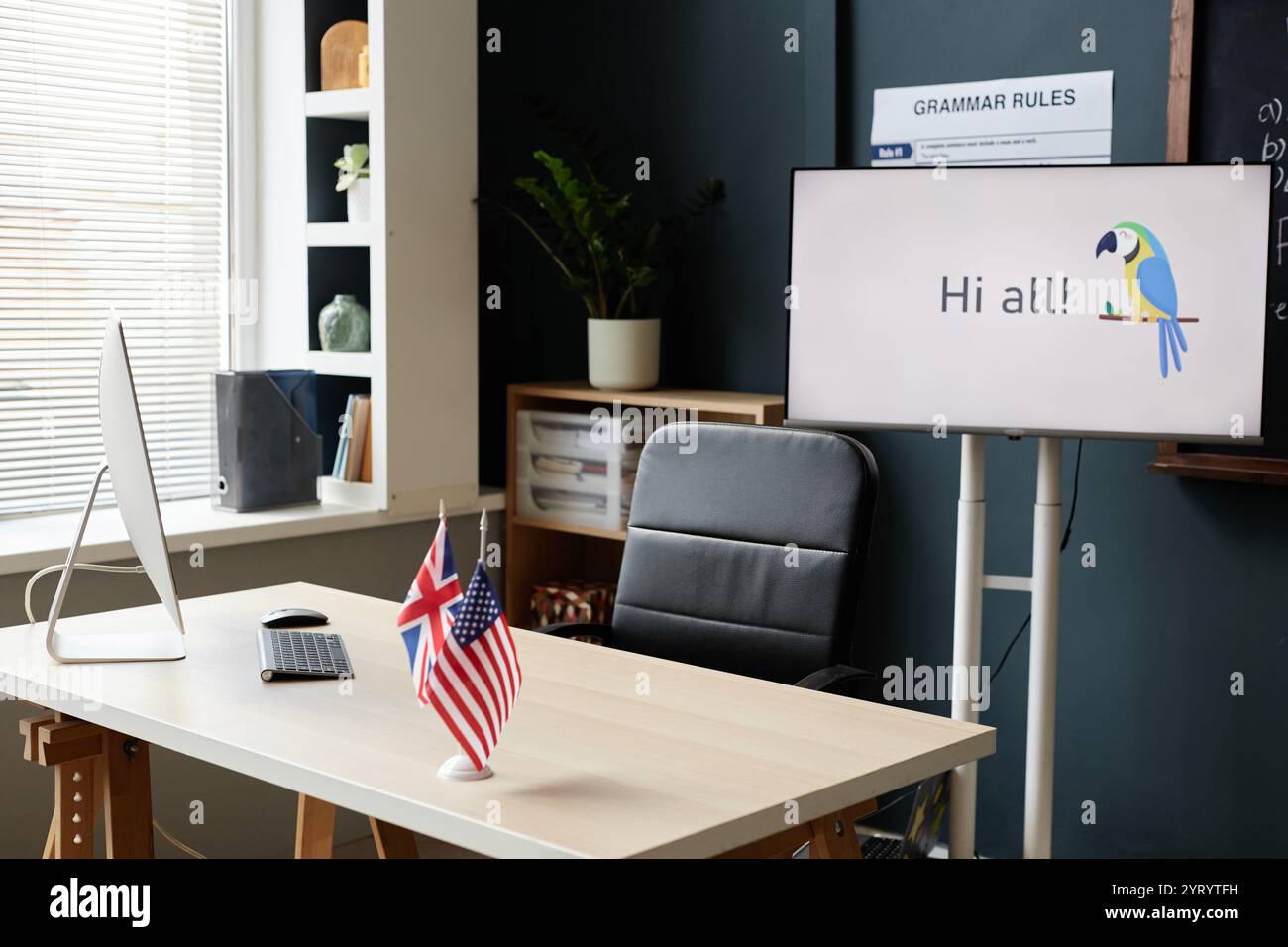 Teachers working desk equipped with computer and digital display in ...