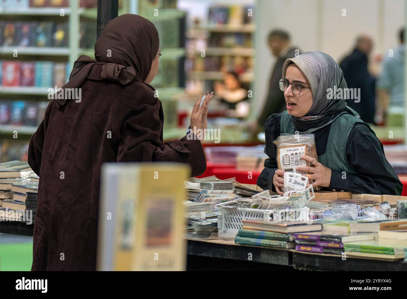 People attend the Iraq's International Book Fair, in Baghdad, Iraq, Thursday, Dec. 5, 2024. (AP ...