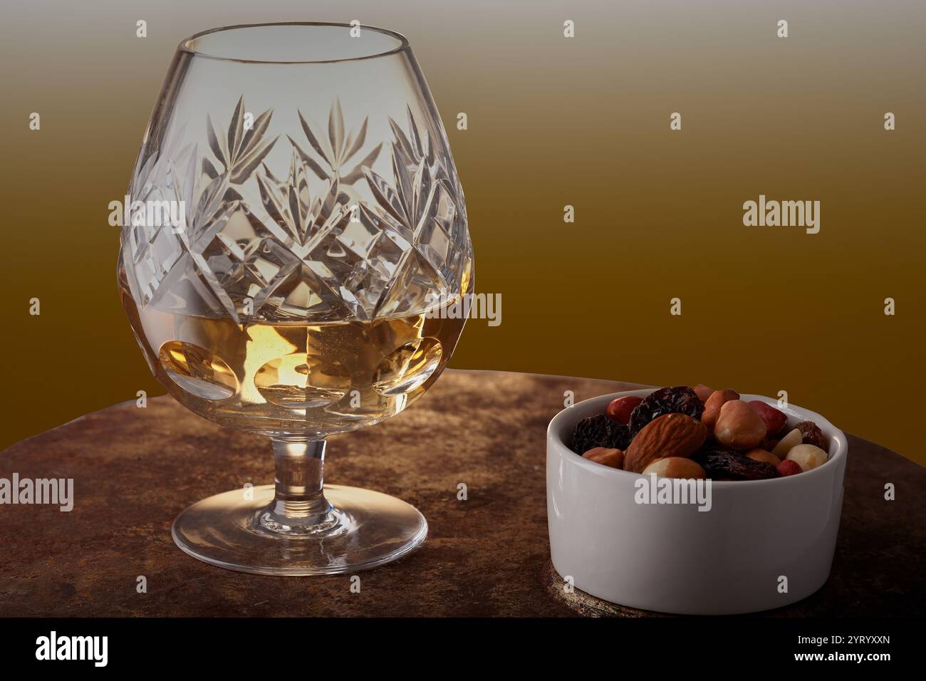Glass of brandy with some nuts at the side Stock Photo - Alamy