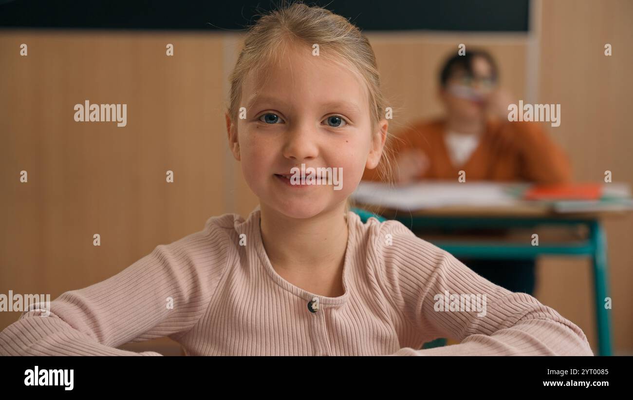 Caucasian clever happy little girl school test study task exam writing ...